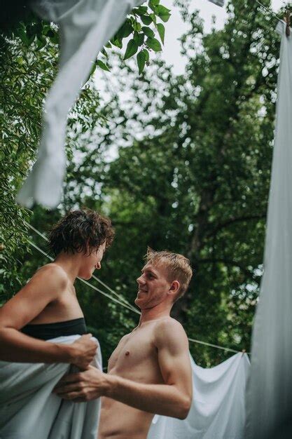 Premium Photo Side View Of Shirtless Man With Arms Raised Against Trees