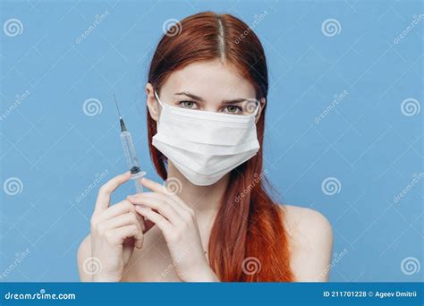 Woman On A Blue Background In A Medical Mask And Syringes In Hand Botox Injection Beauty Care