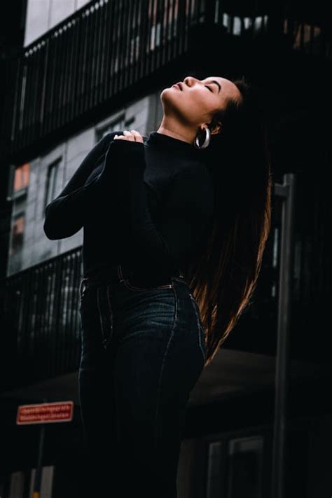 Low Angle Shot Of A Woman In Streetwear Posing For The Camera · Free