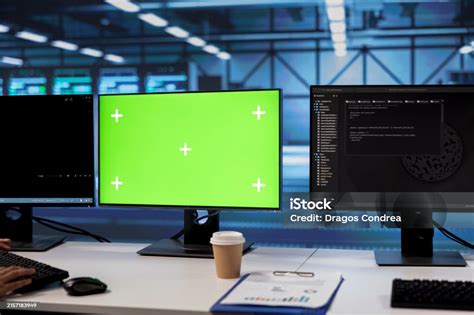 Lines Of Code Running On Green Screen Computers In Data Center Stock