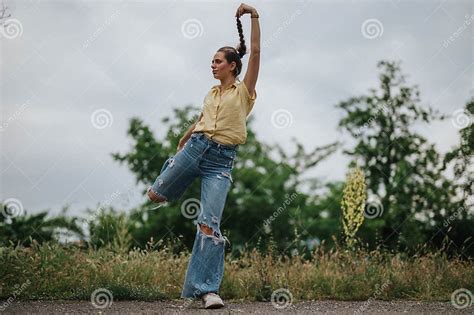 Girl Having Fun Alone In The Park While Striking A Playful Pose Stock