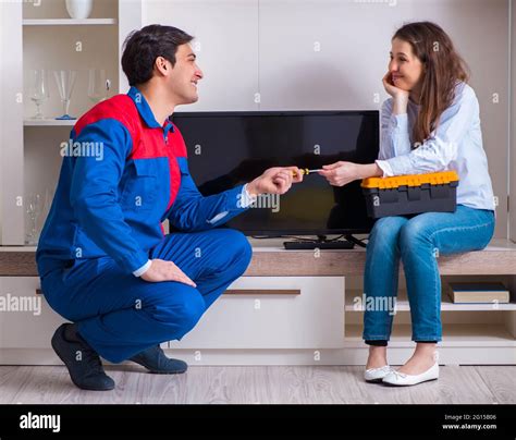 The Repairman Repairing Tv At Home Stock Photo Alamy