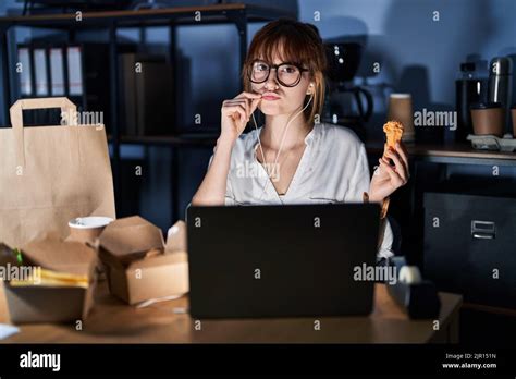 Young Beautiful Woman Working Using Computer Laptop And Eating Delivery