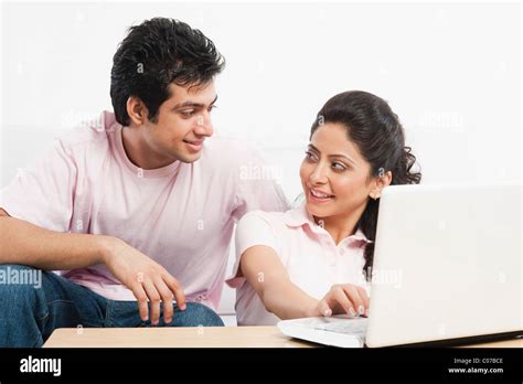Couple Using A Laptop Stock Photo Alamy
