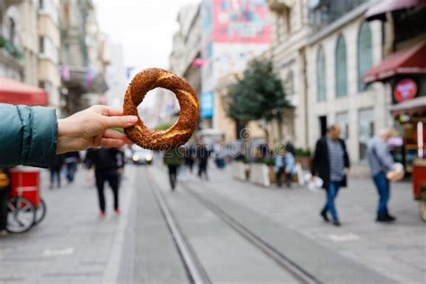 Turkish Bread Simit In Hand Traditional Baked Bagel In Turkey Sold As