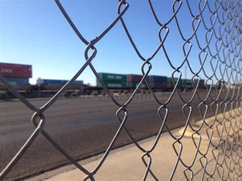 Fence In Focus With Train Passing By In Distance Stock Image Image Of