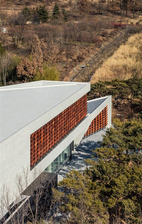 Moveable Wooden Screens Are Set Into Concrete Facades Of Wood Museum