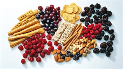 Assorted Healthy Snacks Including Berries Nuts Rice Cakes And Dried