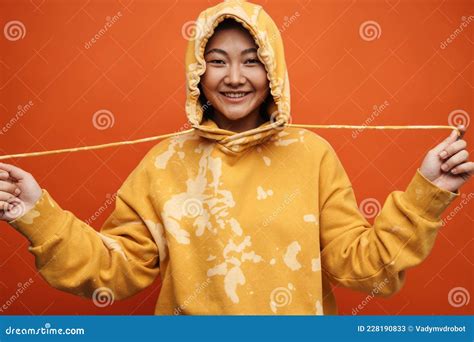 Asian Teen Girl Wearing Hoodie Smiling And Looking At Camera Stock