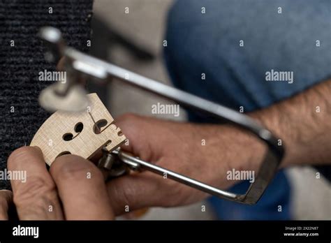 Top View Of Unrecognizable Latin American Luthier Using A Hacksaw To