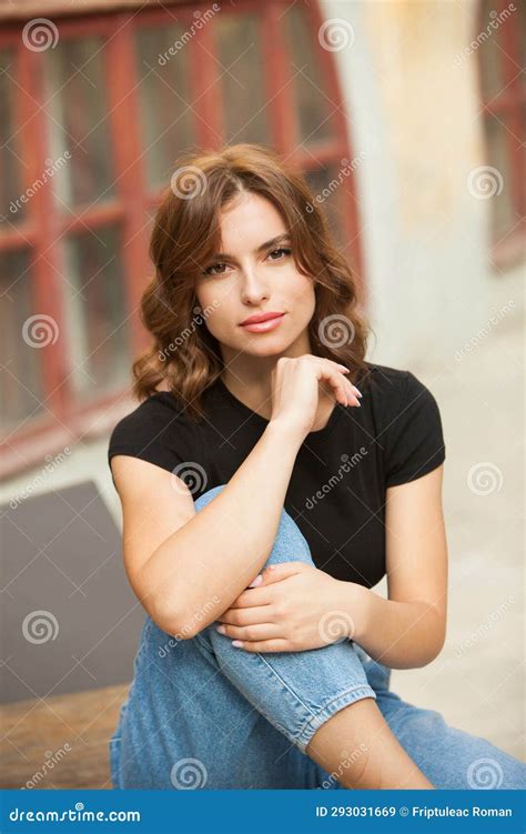 Portrait Of A Beautiful Young Woman With Long Brown Hair Smiling At The