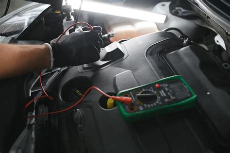 Premium Photo Car Mechanic Is Using A Multimeter With Voltage Range Measurement To Check The