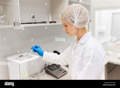 Woman With Sulphuric Acid And Scale At Laboratory Stock Photo Alamy