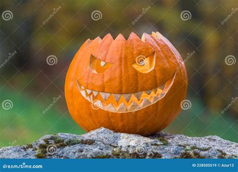Scary Smiling Halloween Pumpkin With Nasty Face On A Stone Stock Image