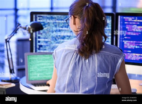 Female Programmer Working In Office At Night Stock Photo Alamy