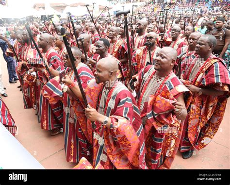 Men In Their Cultural Attire Removing Their Cap To Pay Homage To The