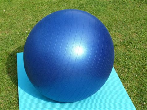 Swiss Ball Placed On Yoga Mat Outdoors