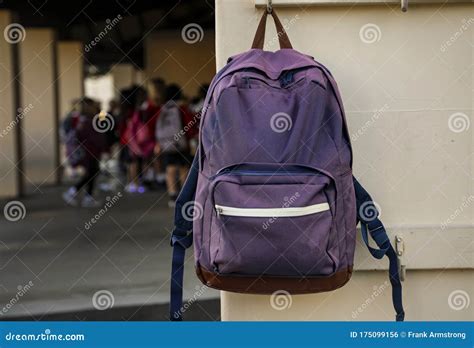 A Horizontal Shot Of Purple Backpack Hanging On Hook On Wall At