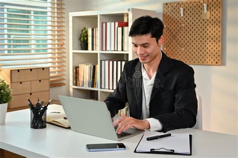 Photo Of Smiling Adult Male Manager Typing Business Email On Laptop Computer Business And