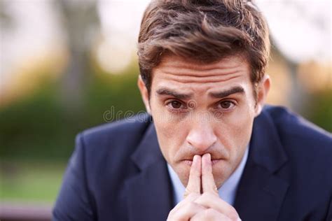 Hes Got A Lot On His Mind A Serious Businessman Frowning While Sitting