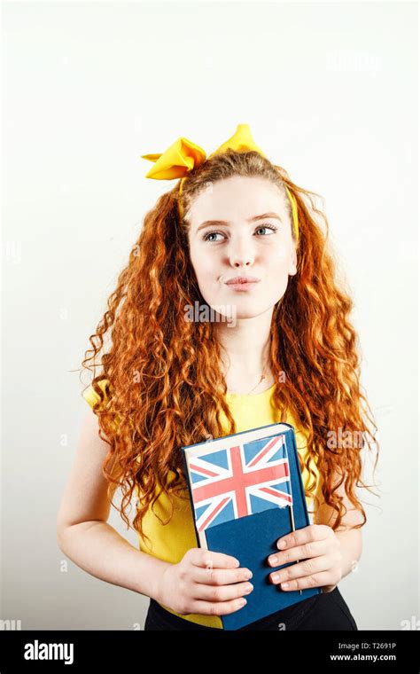 Curly Redhead Girl With A Yellow Bow On Her Head Wearing Yellow T Shirt