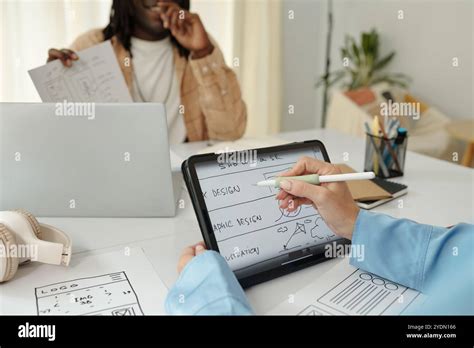 Diverse Group Collaborates On Ui Design Projects In Modern Workspace