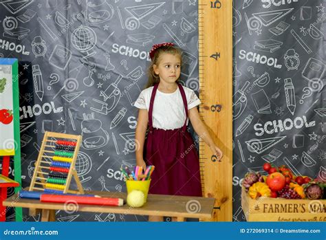 Cute Schoolgirl Girl In The Classroom Classroom Blackboard Large Ruler Table Vegetables