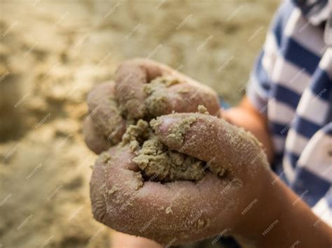 Premium Photo Cropped Image Of Boy Playing In Mud