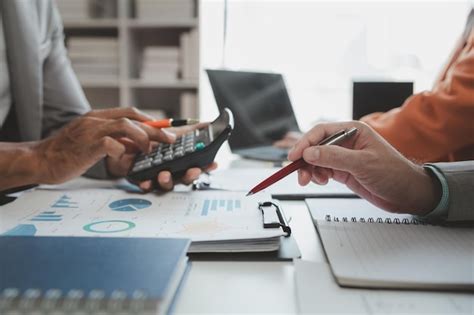 Premium Photo Calculate The Numbers According To The Report Sent To The Meeting They Are