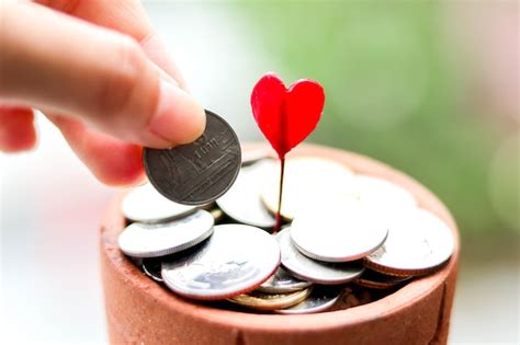 Premium Photo Close Up Of Cropped Hand Inserting Coin In Container