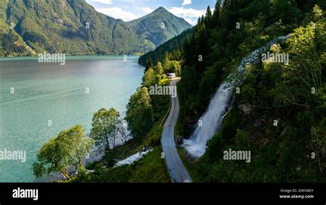 Passing By Dramatic Waterfall Cascading Down Rocky Cliffside