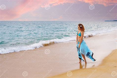 A Beautiful Girl In A Bikini On A Wild Beach Bathing In The Clear
