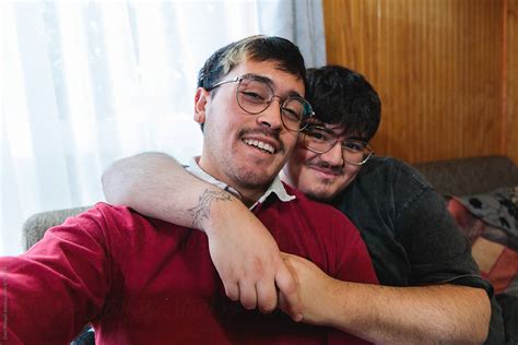 Latin Gay Couple Taking A Selfie On Sofa At Home By Stocksy