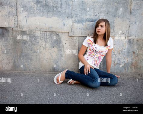 Sad Girl Sitting Against Wall