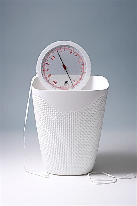 A White Weighing Scale Sitting In An Empty Bucket Background Wallpaper Image For Free Download