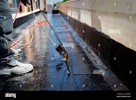 Worker Is Heating Melting Bitumen Waterproofing Installation Over