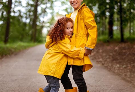 Ginger Sister Hugging Brother In Park Premium Photo