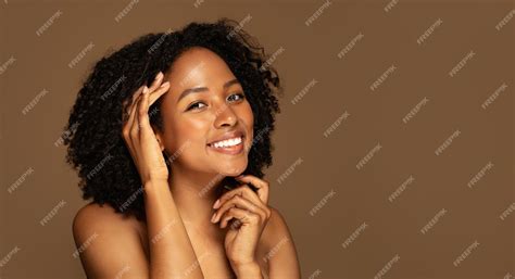 Premium Photo Cheerful Young Black Woman Posing Topless On Brown