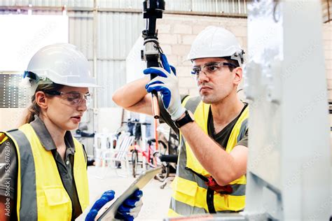 Architect Team Electronic Technician Man And Woman Controlling Remote