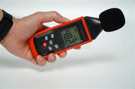 Hand Holding A Digital Sound Level On A White Background Sound Level Meters Are Commonly Used In
