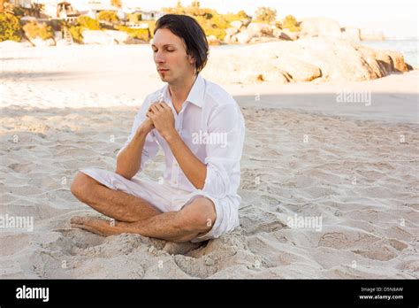 Man Meditating On Beach Stock Photo Alamy