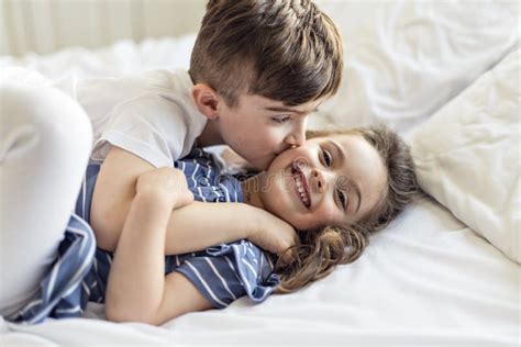 Brother And Sister Having Fun Together On Bed Stock Photo Image Of Male Lying