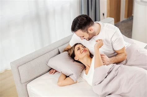Premium Photo A Lovely Man Is Waking Up His Wife In The Morning