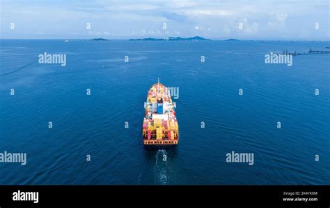 Stern Of Large Cargo Ship Import Export Container Box On The Ocean Sea On Blue Sky Back Ground