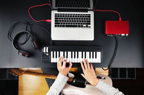 Composer Playing Midi Keyboard Arranging Song On Computer Home Studio Over Royalty Free