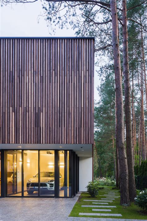 Smilgu House In Lithuania Has A Glass Garage To Display Its Owners Car