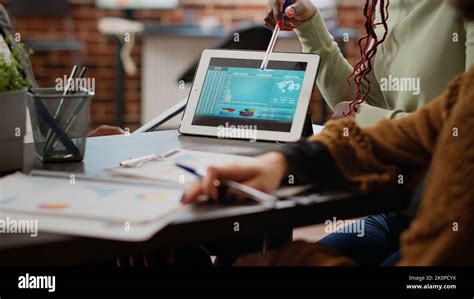 Business People Using Research Infographics On Digital Tablet To Do Software Analysis And Create