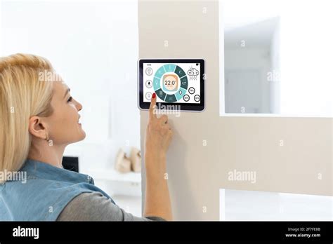 Smart Home Digital Thermostat Touch Screen Woman Touching Touchscreen To Adjust Temperature Of