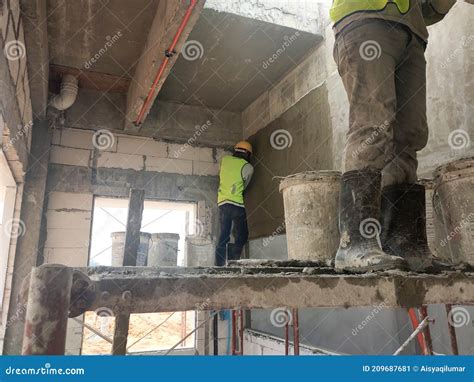Plastering Work By Construction Workers Using The Cement Plaster