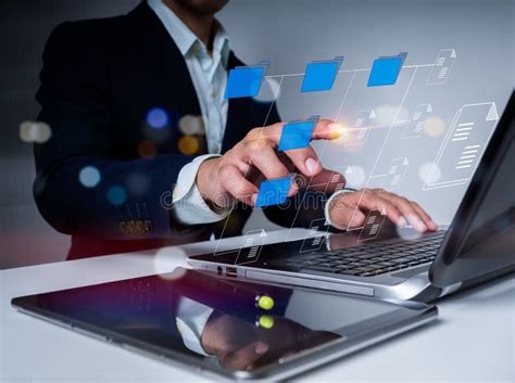 The Businessman Is Using A Laptop Computer To Properly Handle Files
